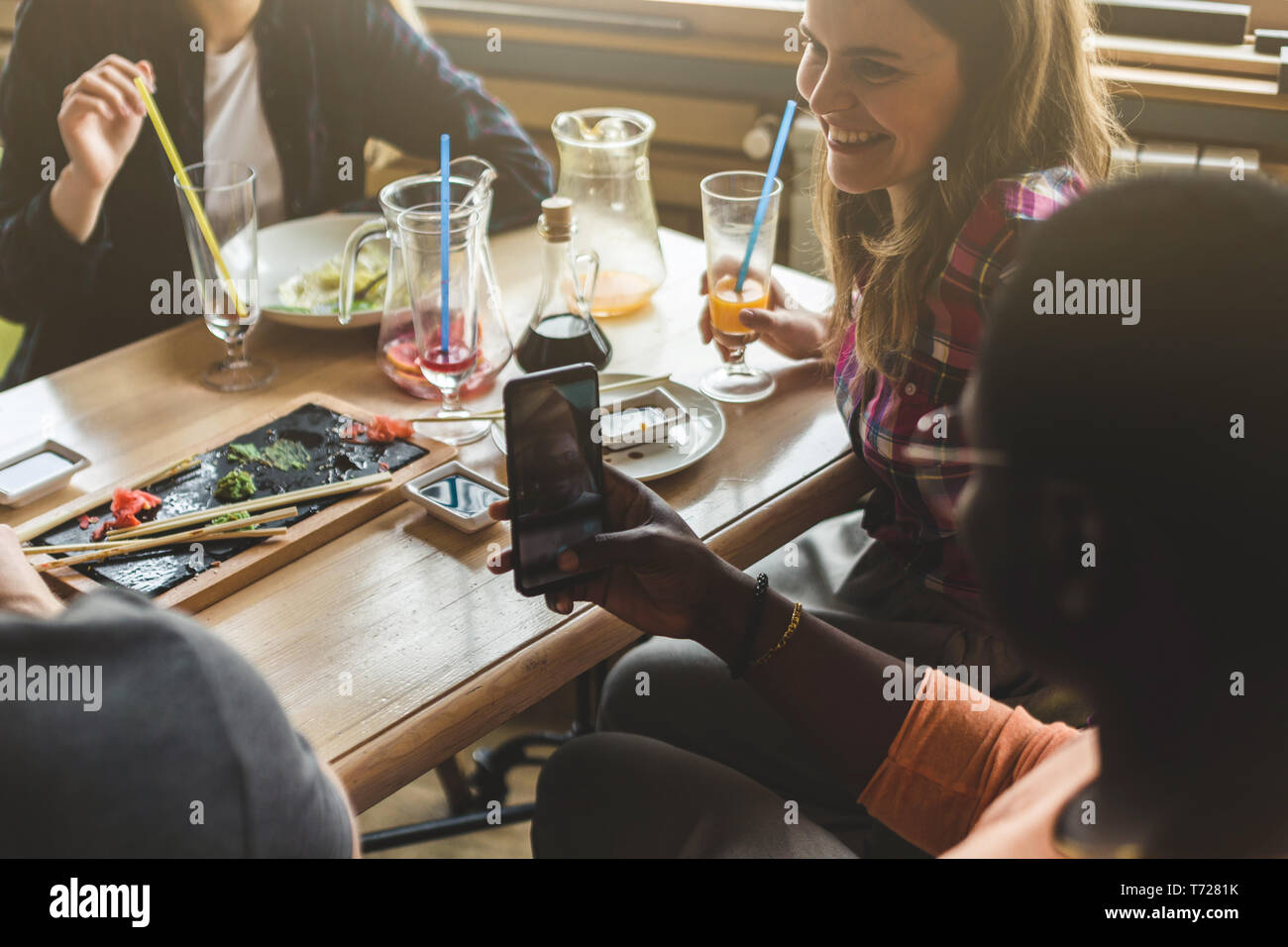 Meet young attractive people in the cafe. Friends chat, have fun, drink ...
