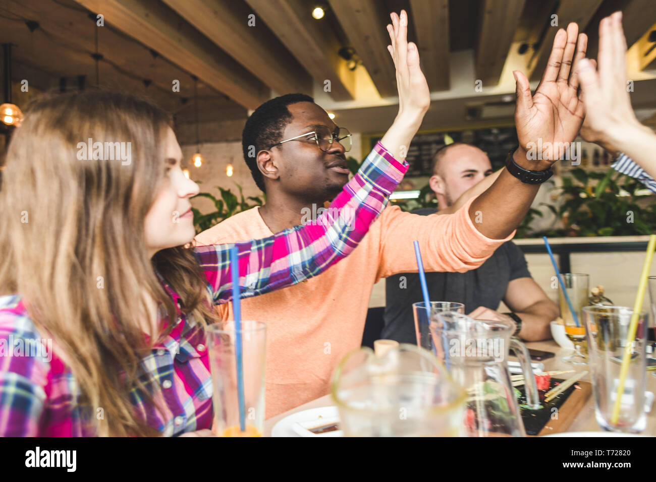 Meet young attractive people in the cafe. Friends chat, have fun, drink ...