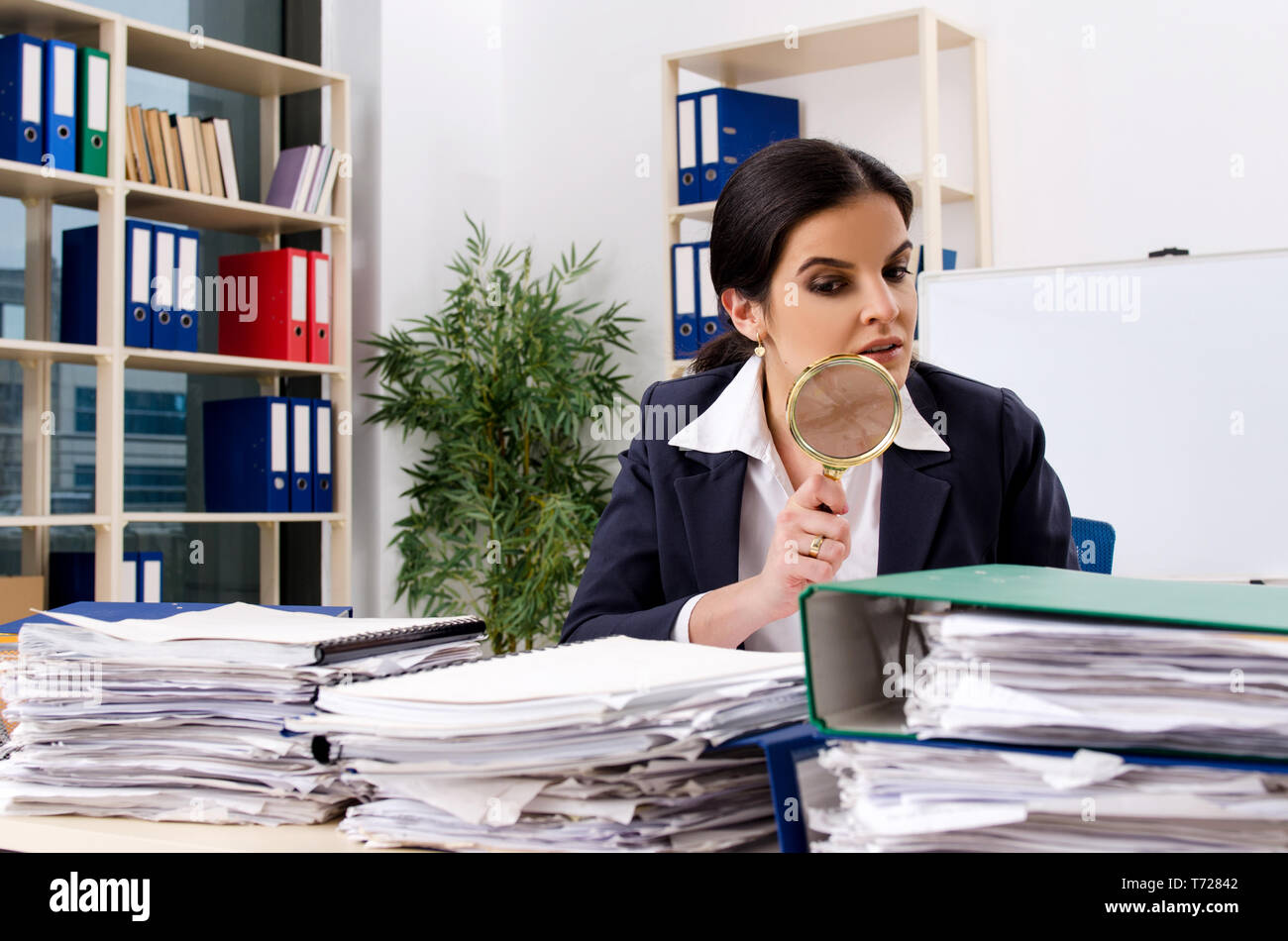 Female employee with too much work in the office Stock Photo - Alamy