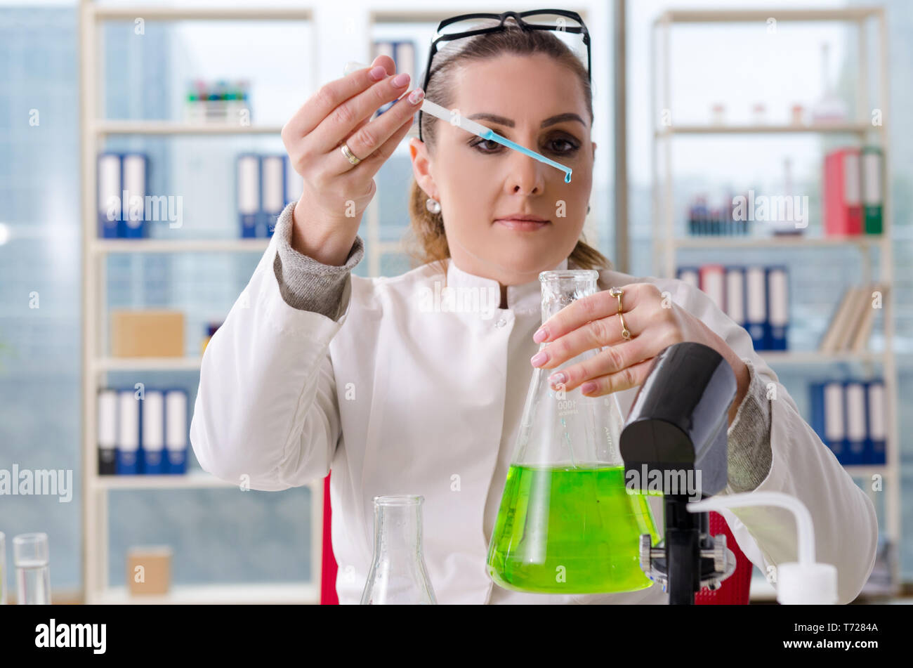 Female scientist mixing chemical hi-res stock photography and images ...