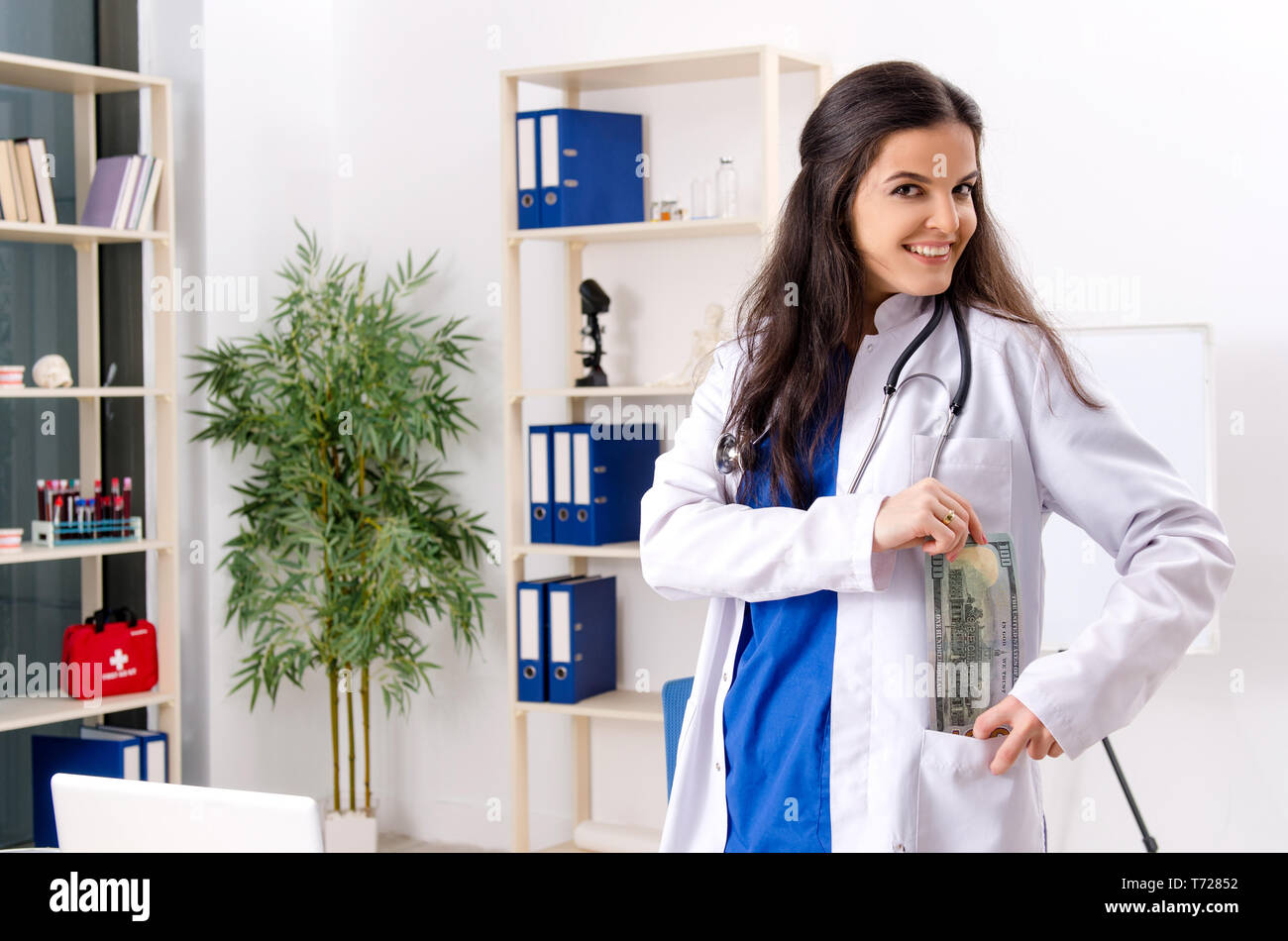 Female doctor money in hi-res stock photography and images - Alamy