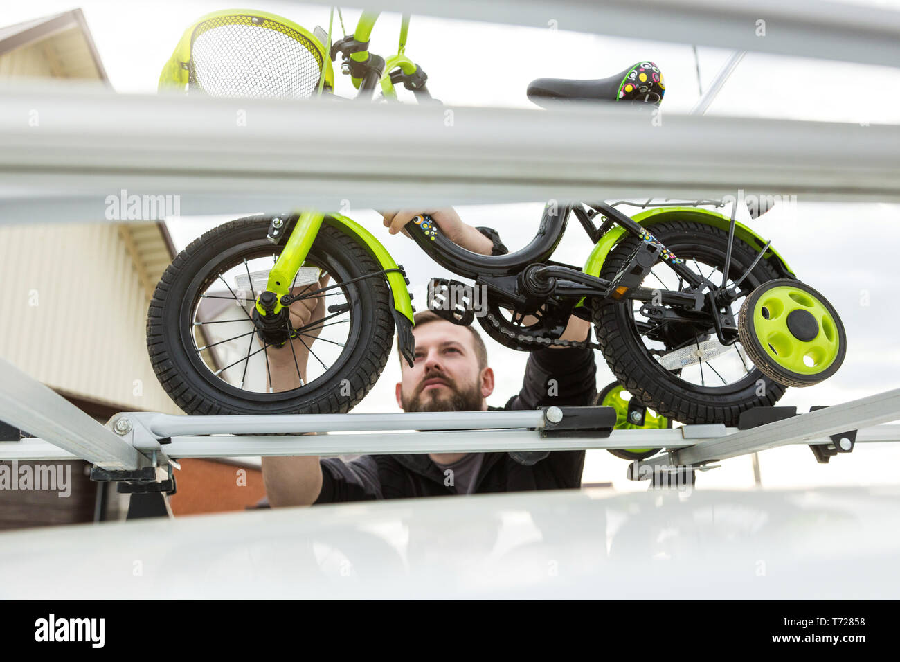 Bicycle transportation - A man fastens and installs a children's ...