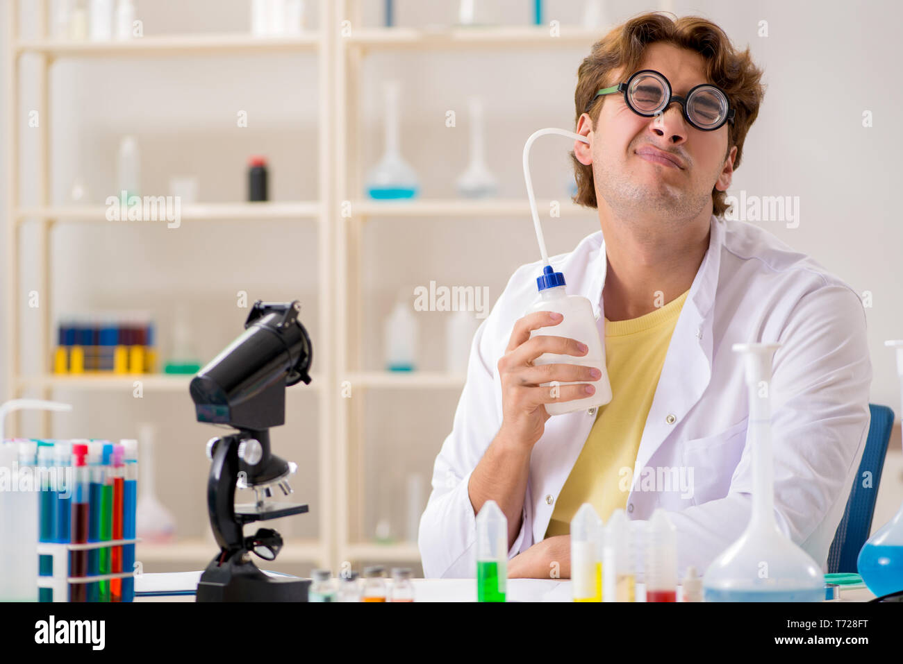 Funny crazy chemist doing experiments and tests Stock Photo - Alamy