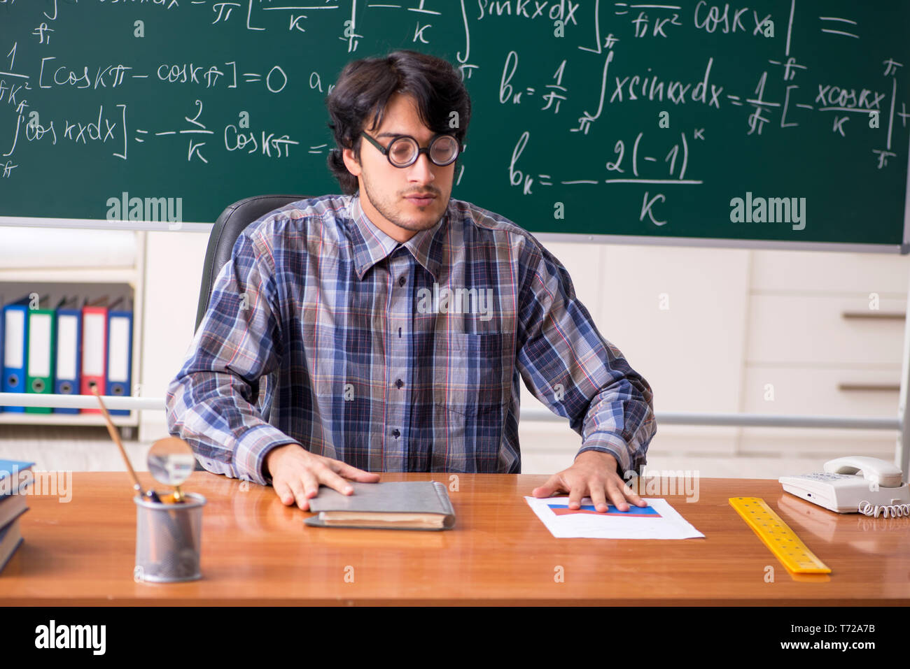 Funny male math teacher in the classroom Stock Photo - Alamy