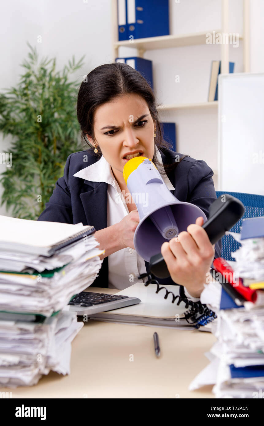 Female employee with too much work in the office Stock Photo - Alamy