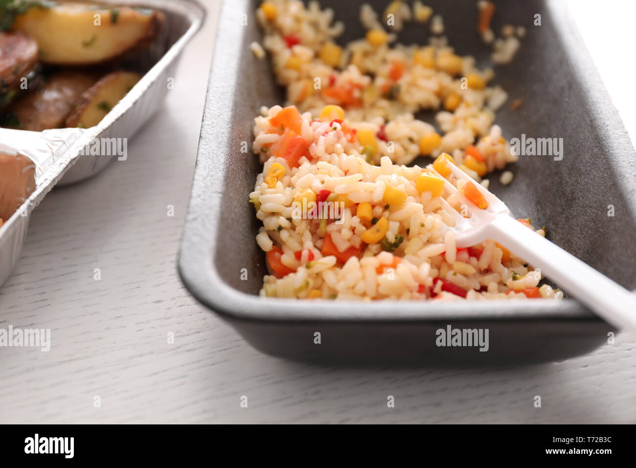 Container with rice on table. Food delivery Stock Photo - Alamy