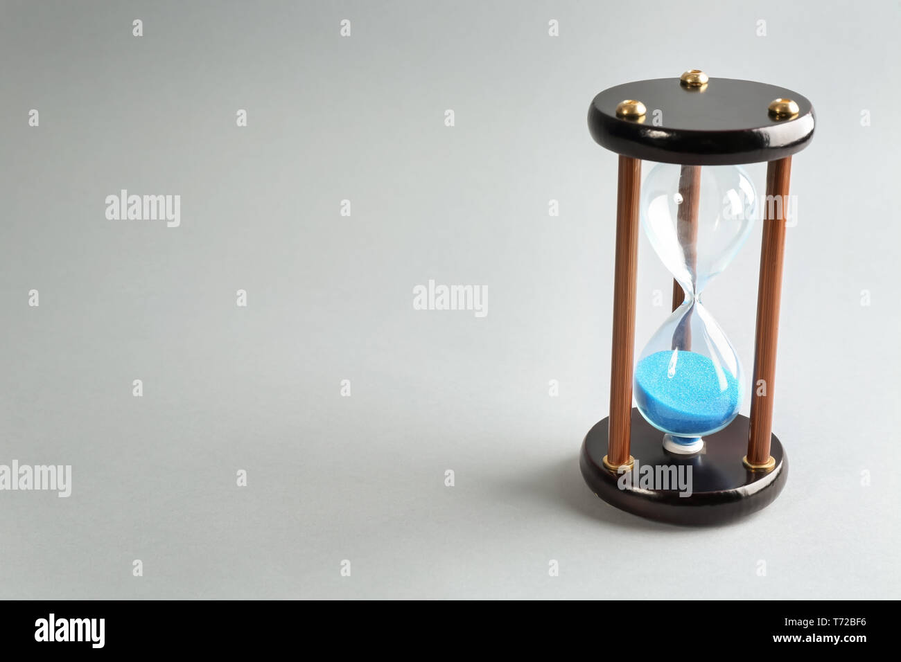 Hourglass on light background. Time management concept Stock Photo - Alamy