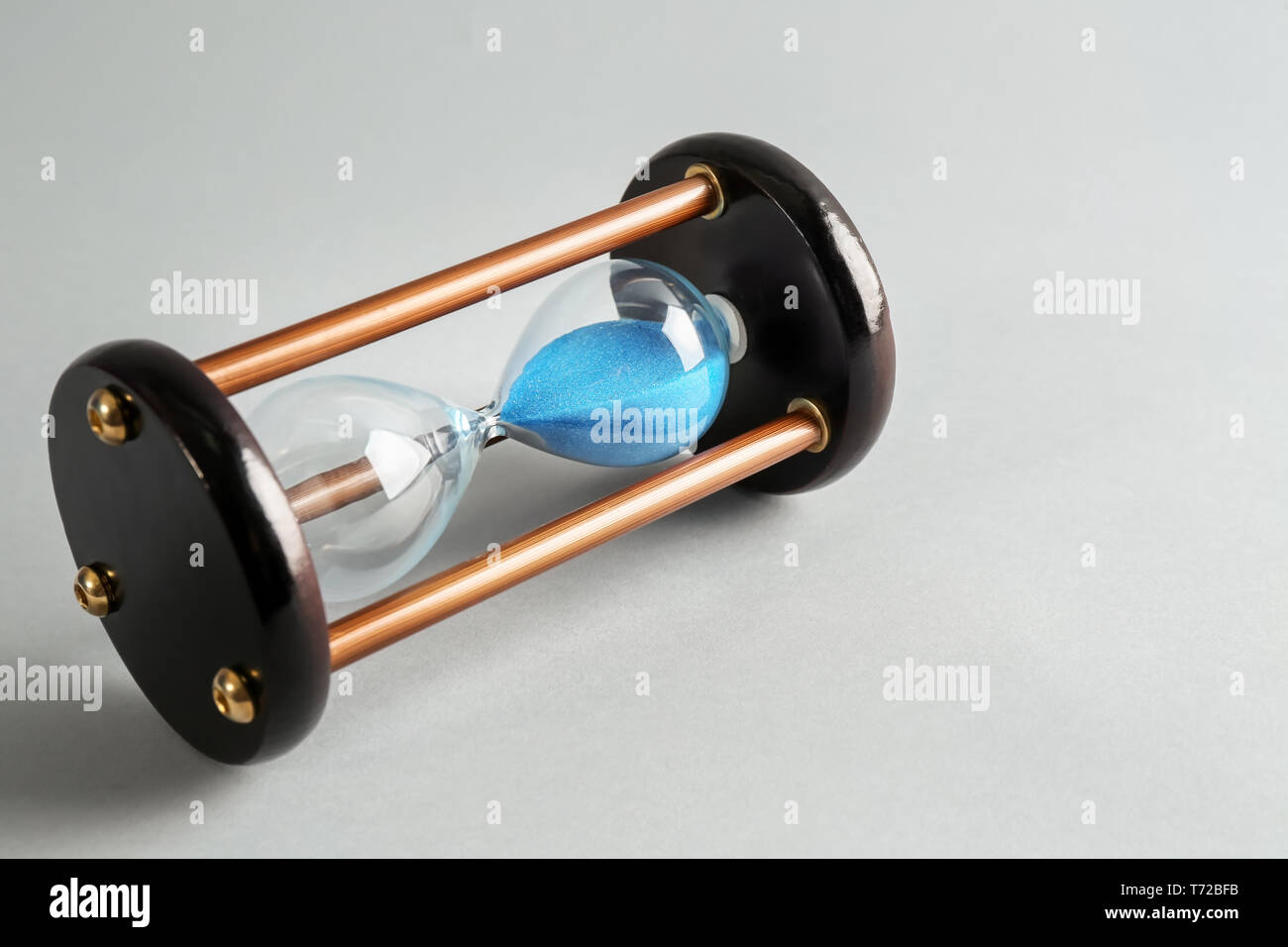 Hourglass on light background. Time management concept Stock Photo - Alamy