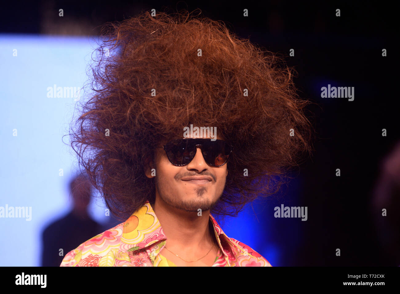Kolkata, India. 02nd May, 2019. A model shows his hairstyle as he walk ...