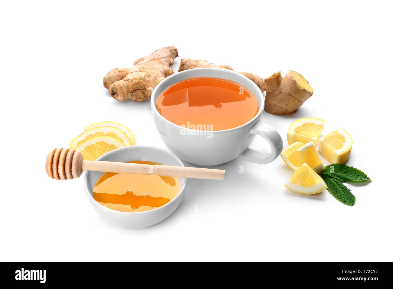 Cup of delicious tea with ginger, lemon and honey on white background ...