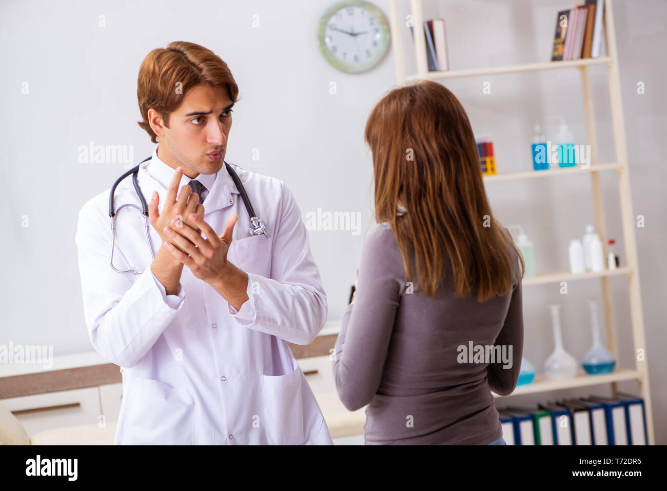 Deaf-mute female patient visiting young male doctor Stock Photo - Alamy