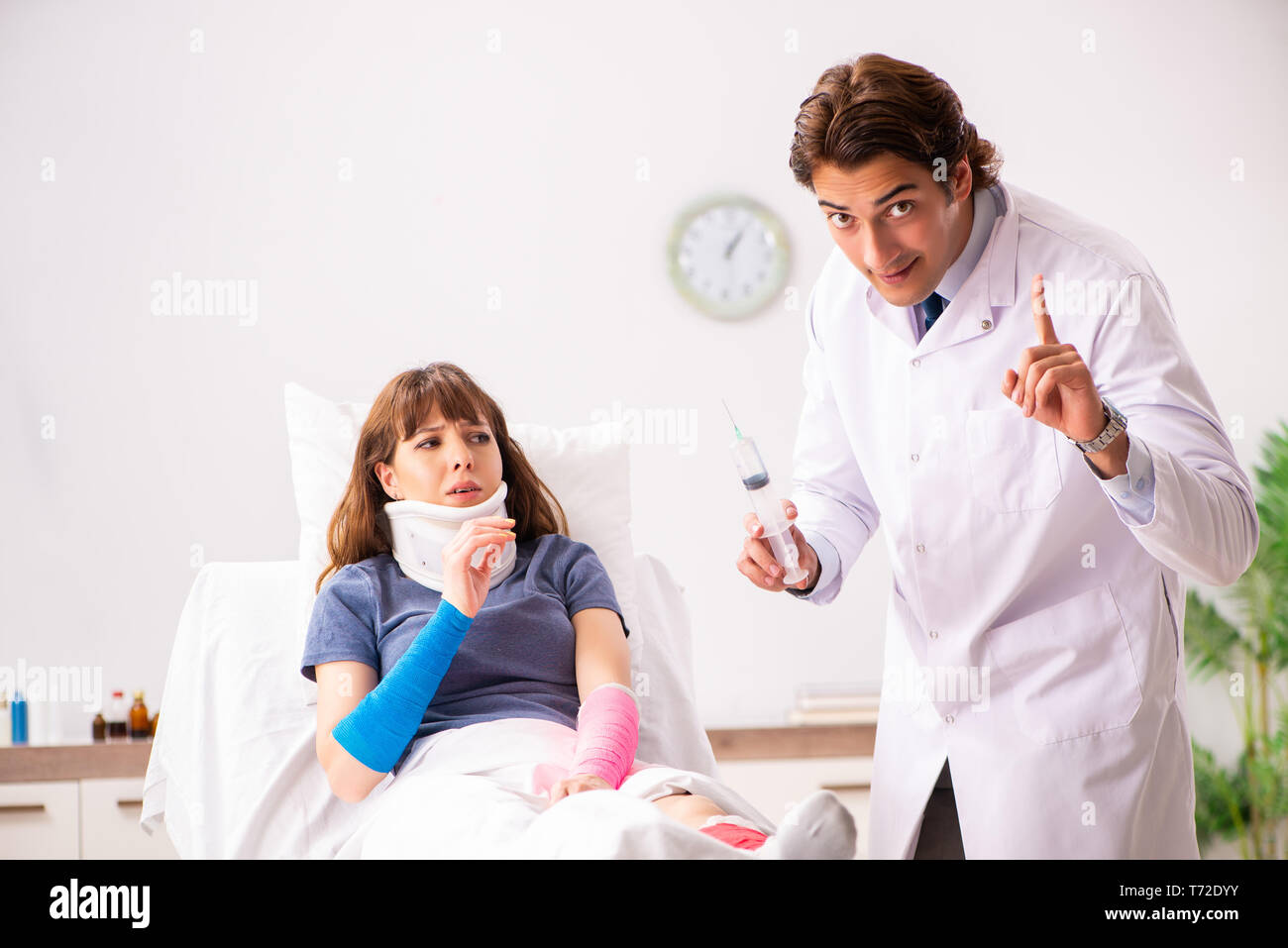 Young doctor examining injured patient Stock Photo - Alamy
