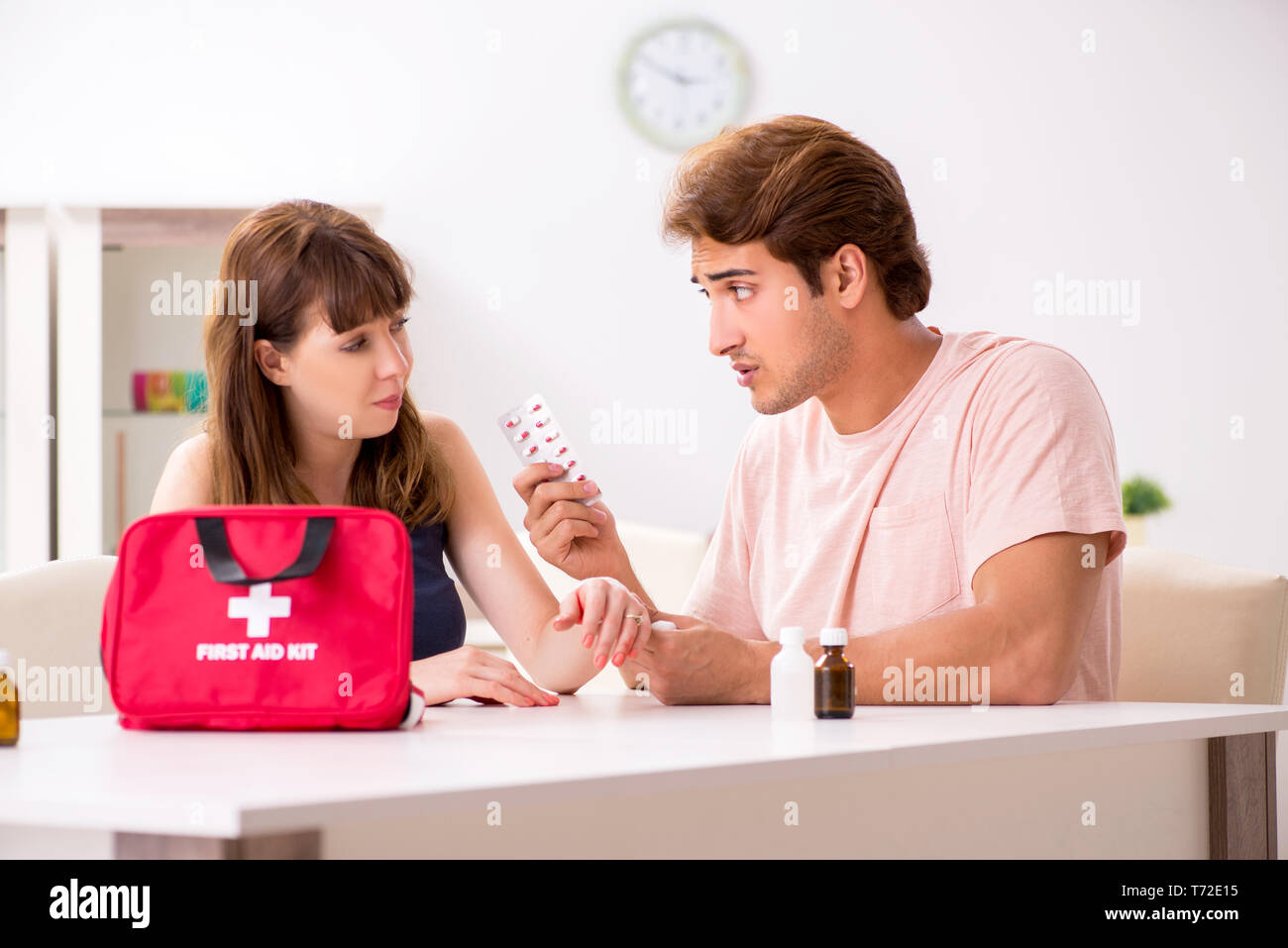 Young family getting treatment with first aid kit Stock Photo - Alamy