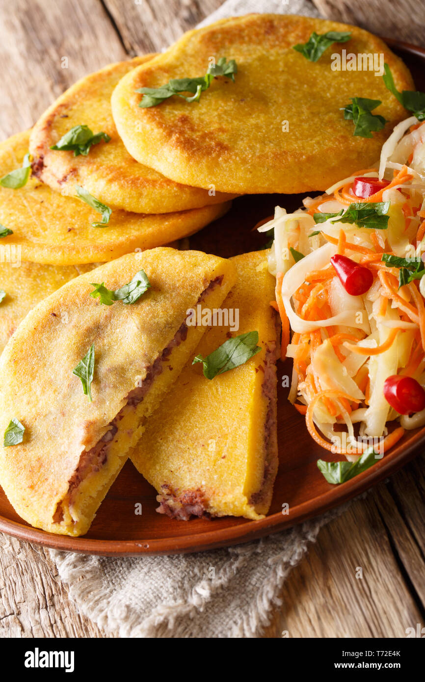 Traditional Latin American pupusas served with curtido closeup on a ...