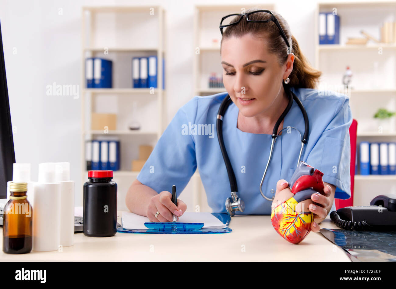 Female doctor cardiologist working in the clinic Stock Photo - Alamy