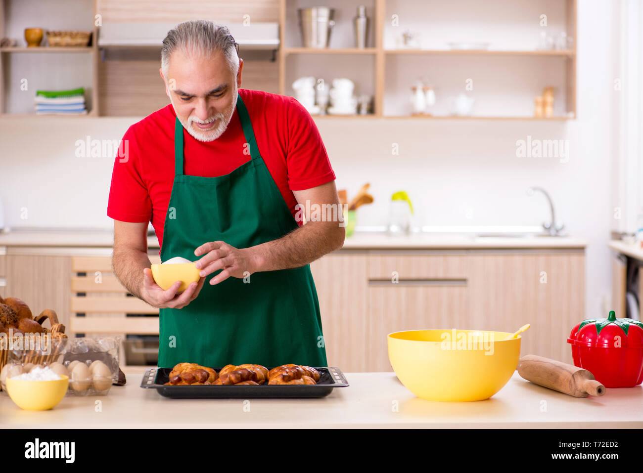Old male baker working in the kitchen Stock Photo - Alamy