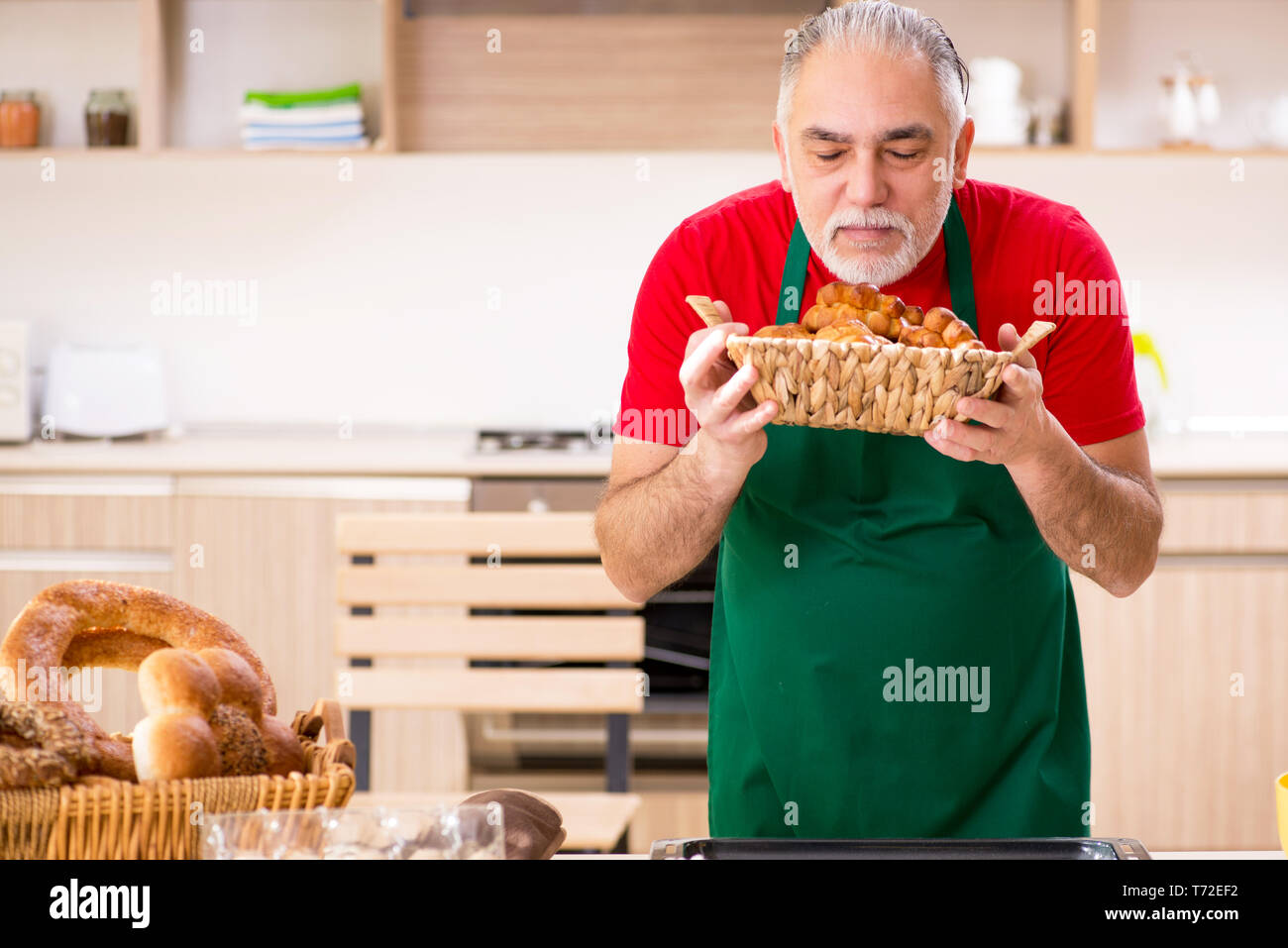 Old male baker working in the kitchen Stock Photo - Alamy