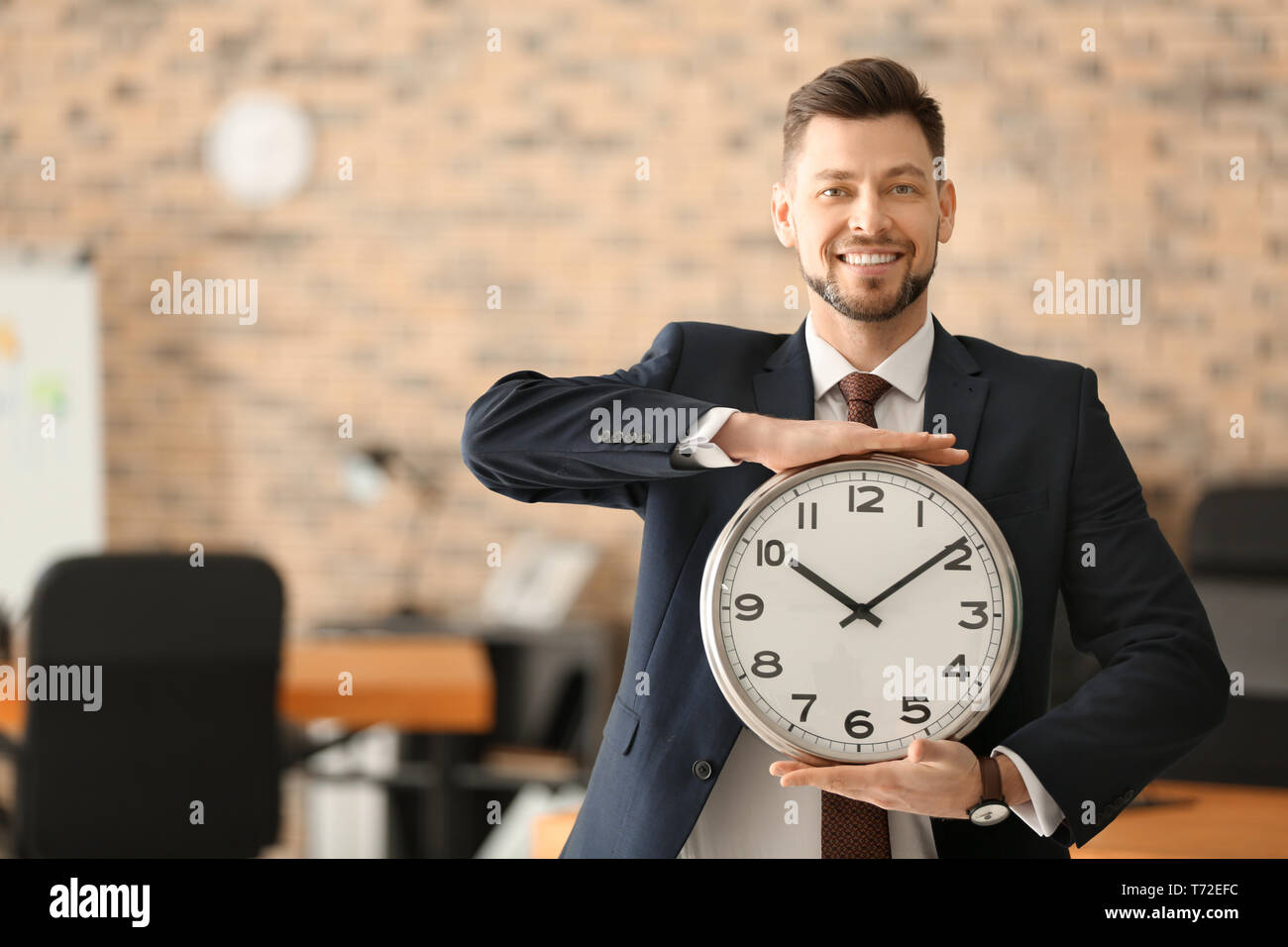 Mature businessman with clock in office. Time management concept Stock ...