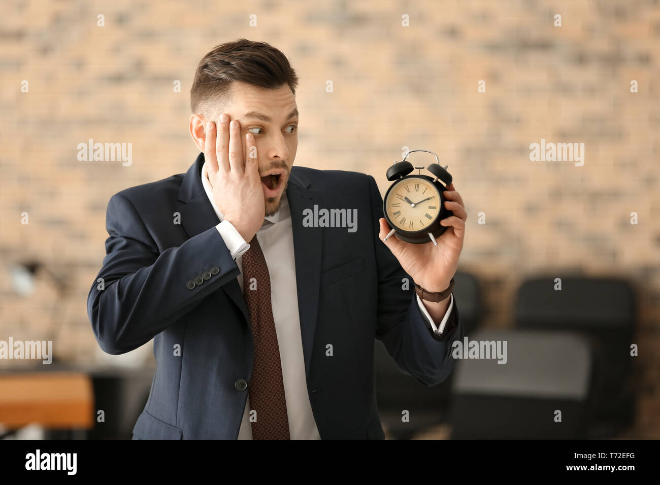Businessman with alarm clock in office. Time management concept Stock ...