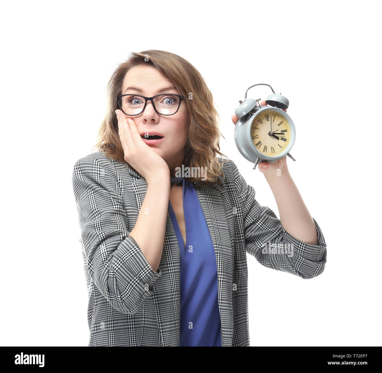Mature woman with alarm clock on white background. Time management ...