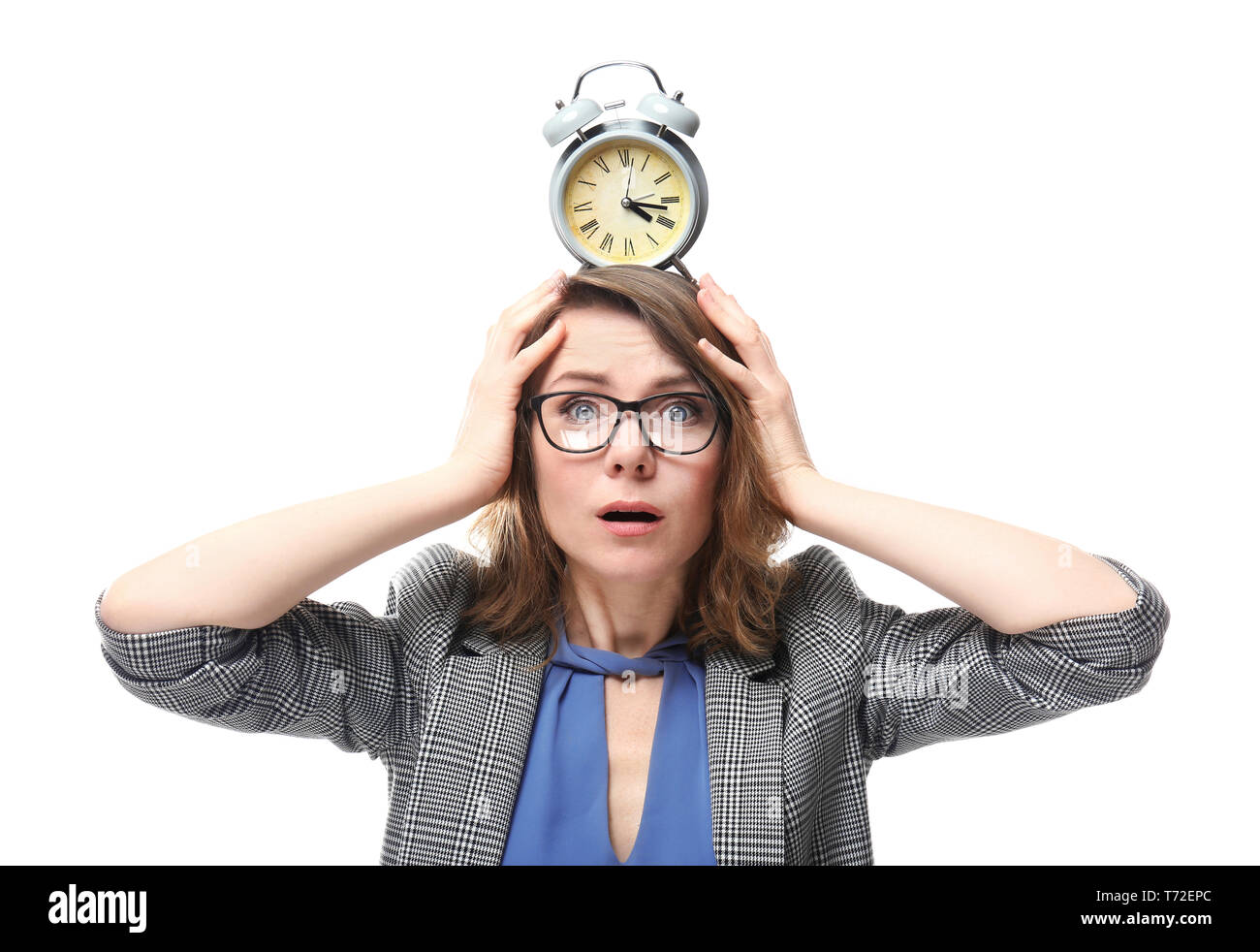 Mature woman with alarm clock on head against white background. Time ...