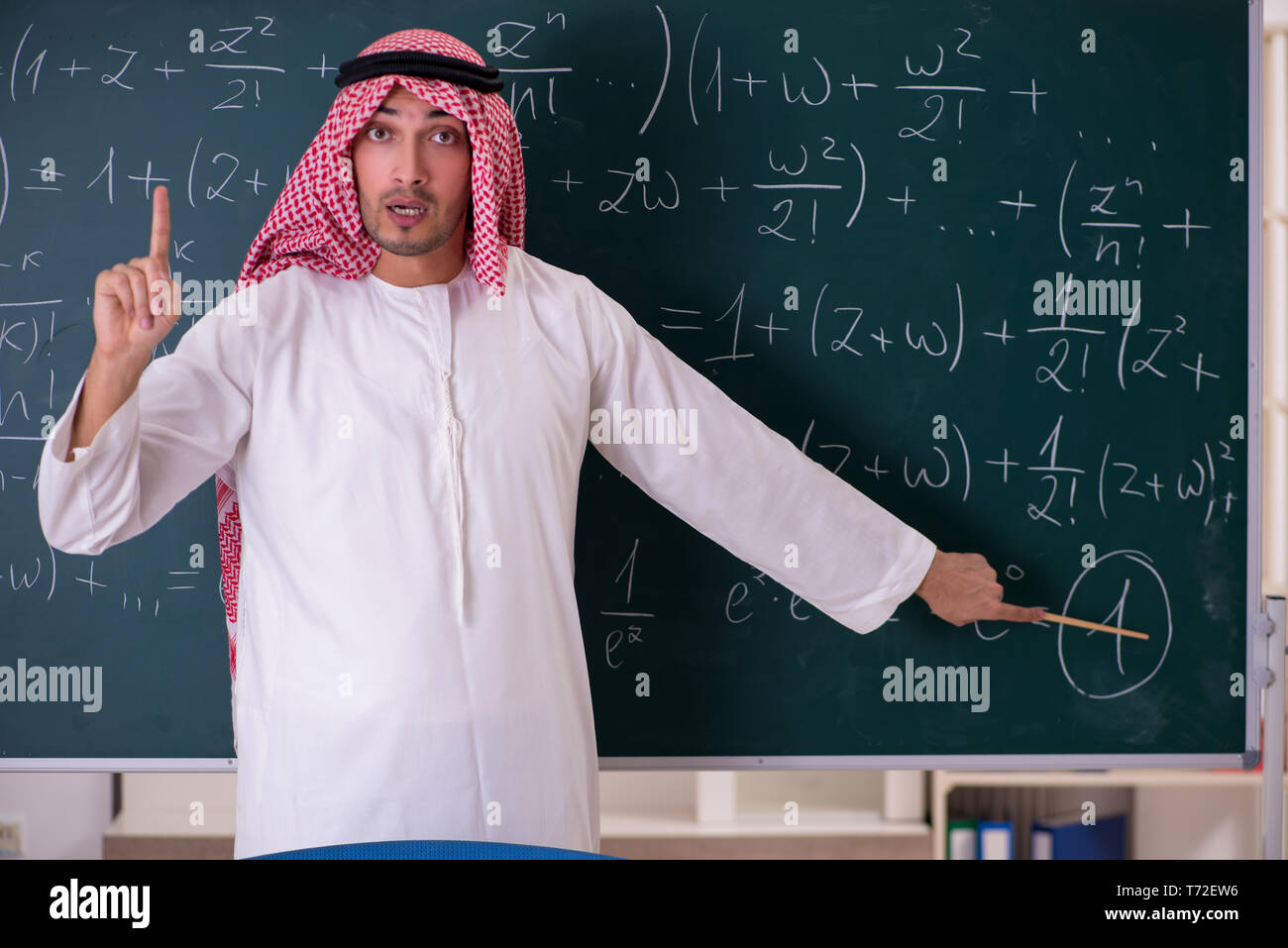 Arab teacher in front of chalkboard Stock Photo - Alamy