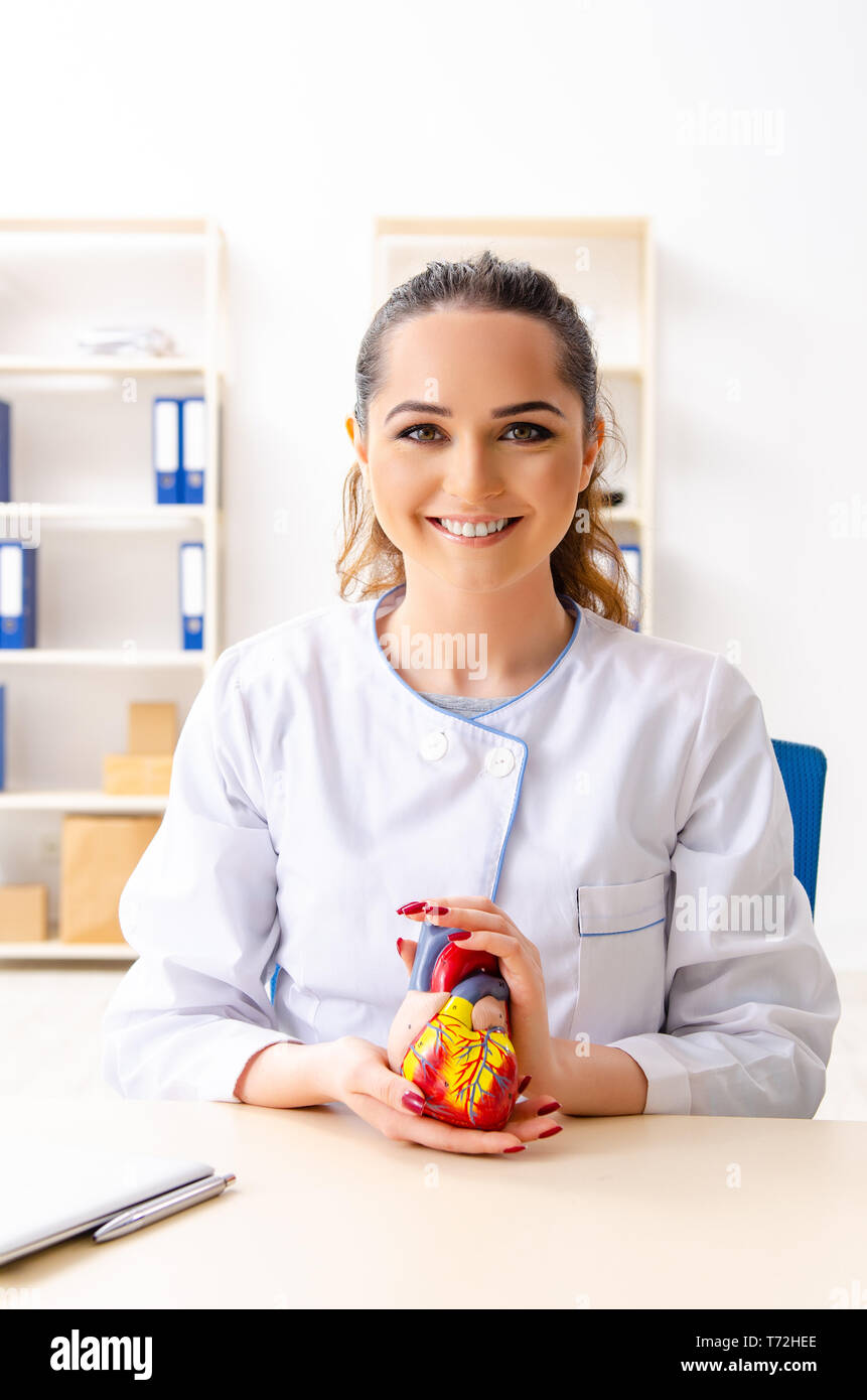 Young female doctor cardiologist sitting at the hospital Stock Photo ...