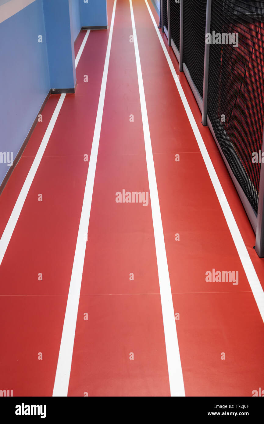 Red running track in children indoor activity park Stock Photo - Alamy