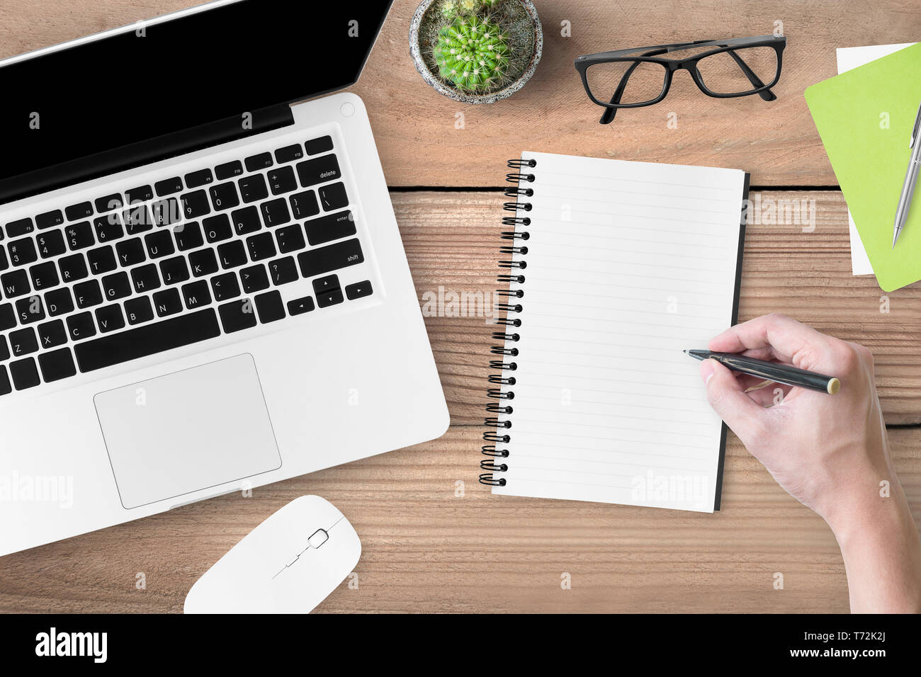 A man is going to write something on the blank notebook page Stock ...