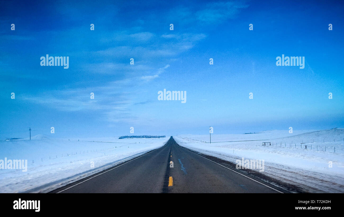 Frosty and snowy landscape in North Dakota. An empty road in winter ...