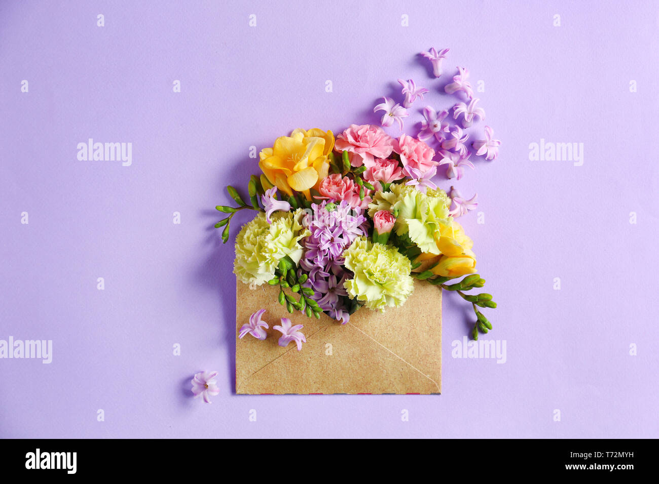 Open mail envelope with flowers on color background Stock Photo - Alamy
