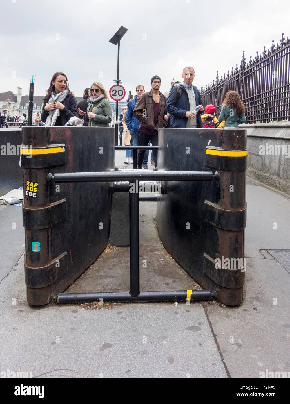 Tourists and commuters approaching safety barriers on Westminster ...