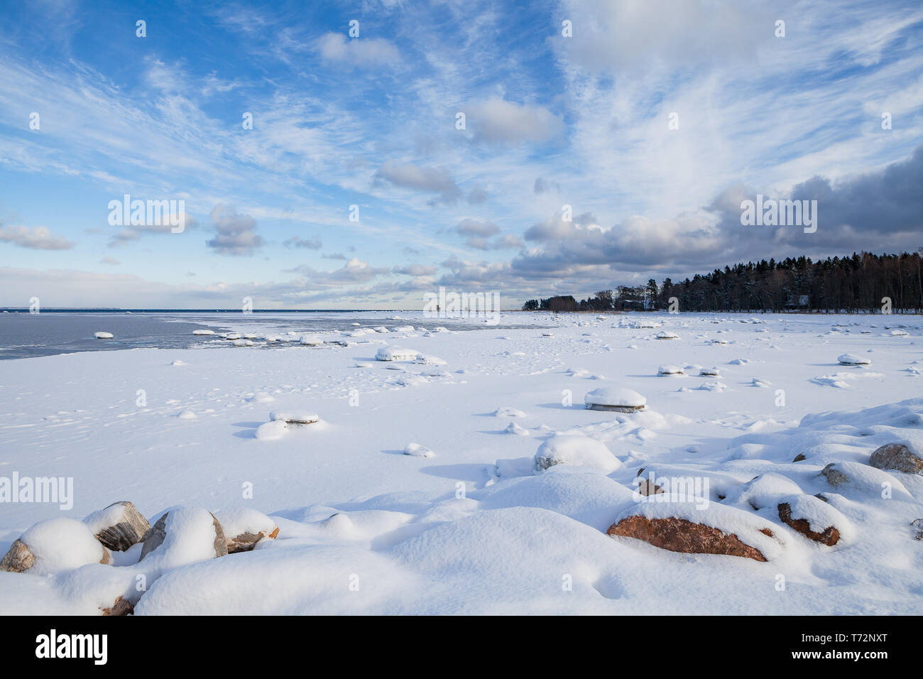 Frozen coast of Baltic sea covered by snow. Boulders, horizon and ...