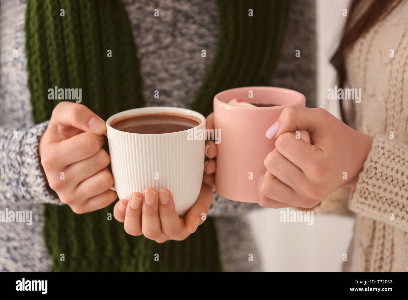 Woman holding two cups brown hi-res stock photography and images - Alamy