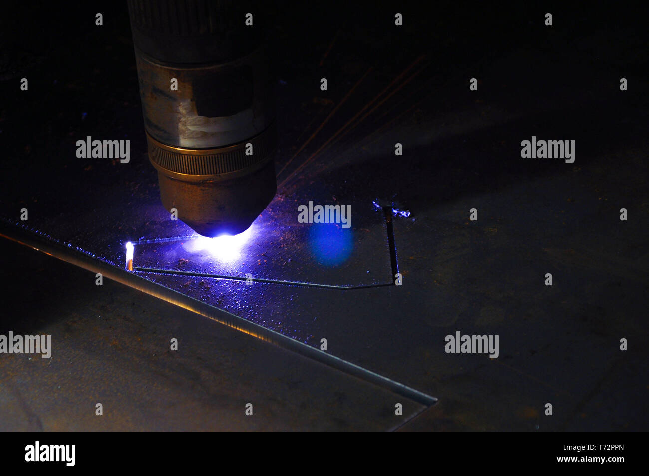 laser cutting torch machine in an industrial plant cuts sheet metal ...