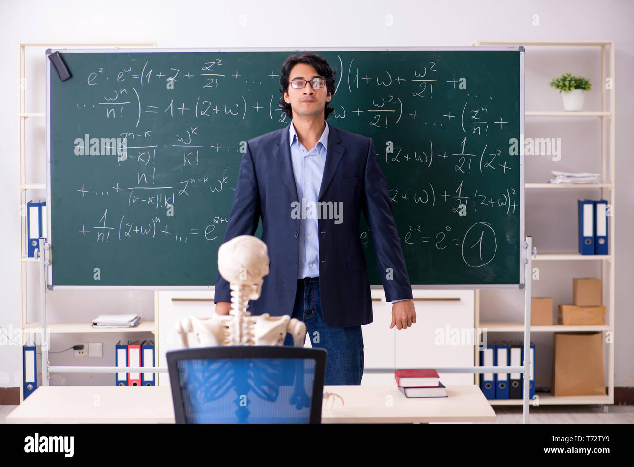 Young male math teacher and student skeleton Stock Photo - Alamy