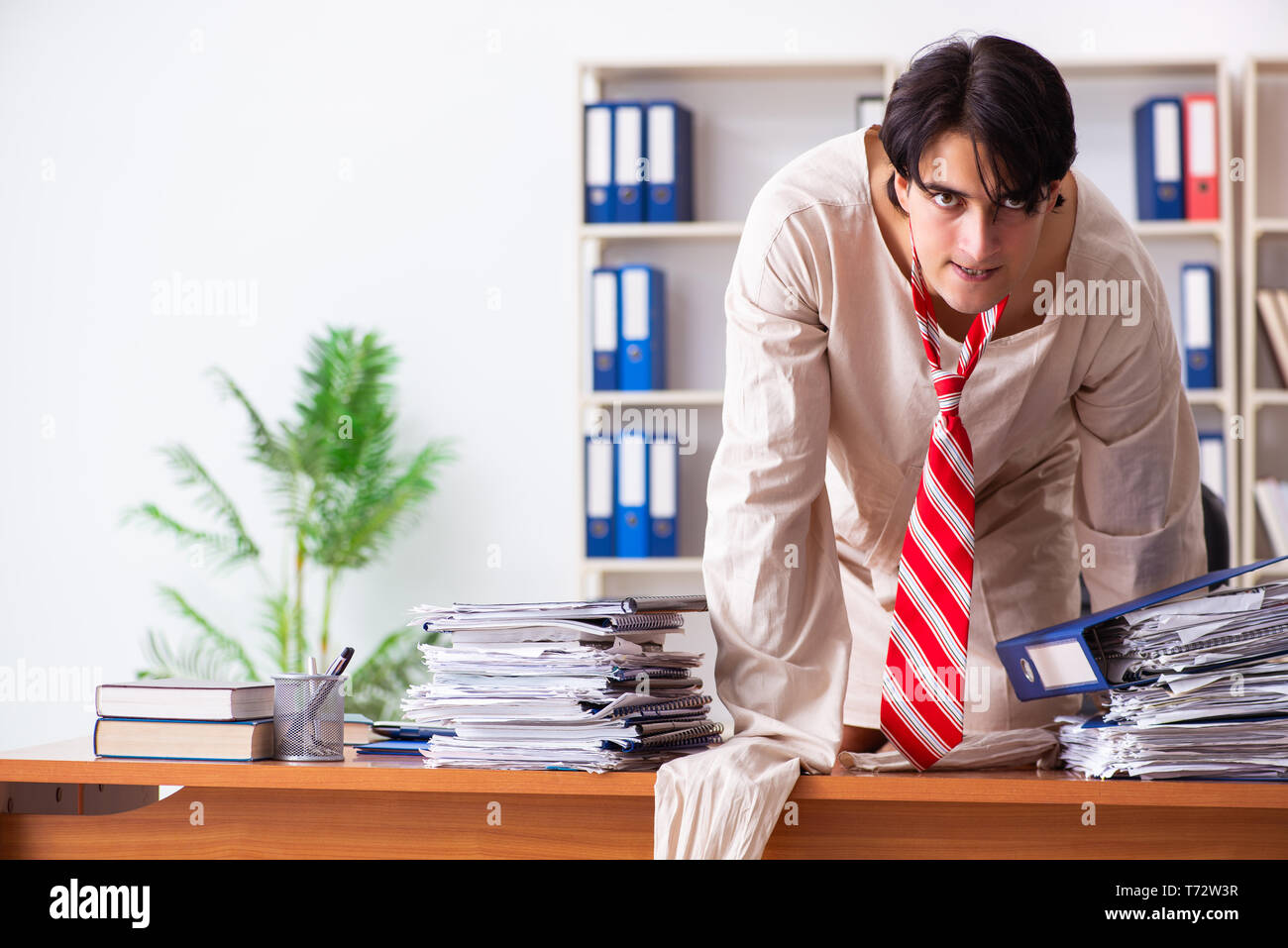 Crazy young man in straitjacket at the office Stock Photo - Alamy