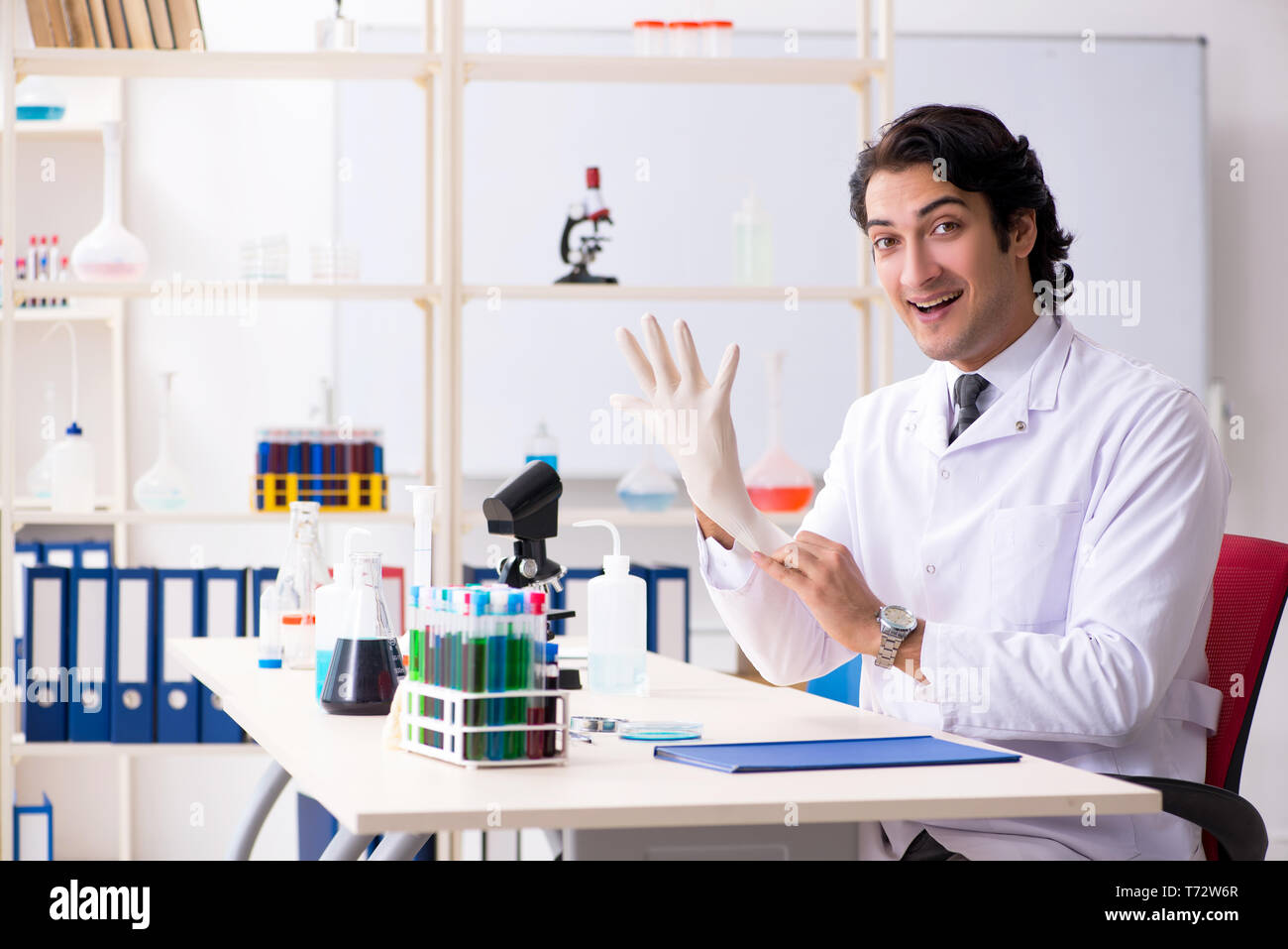 Happy young chemist mixing hi-res stock photography and images - Alamy
