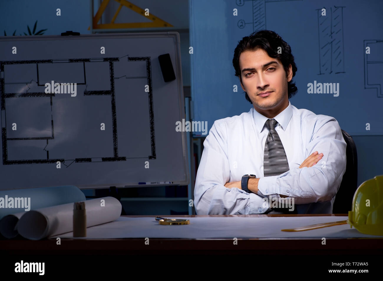 Young construction architect working on project at night Stock Photo ...