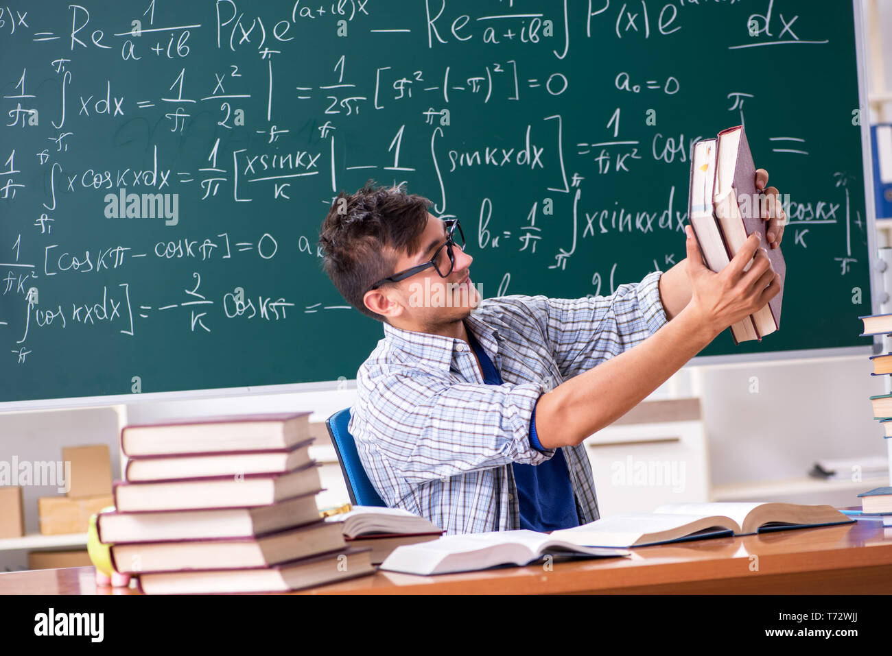 Young male student studying math at school Stock Photo - Alamy