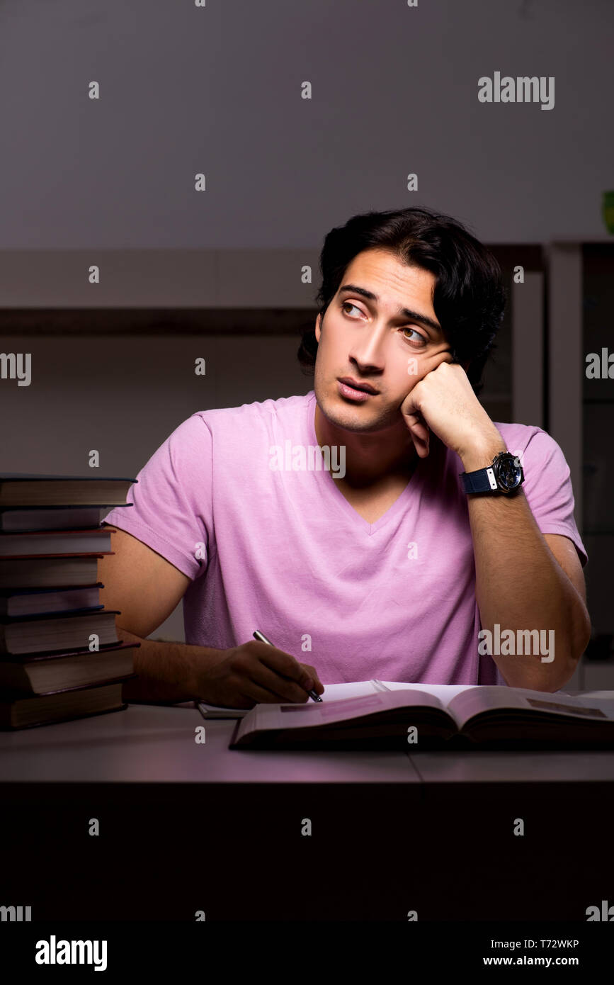 Male handsome student preparing for exams late at home Stock Photo - Alamy