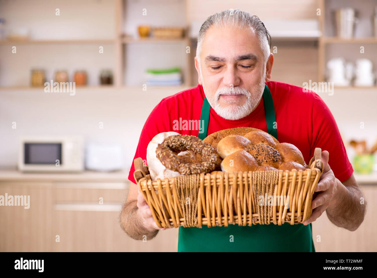 Old male baker working in the kitchen Stock Photo - Alamy