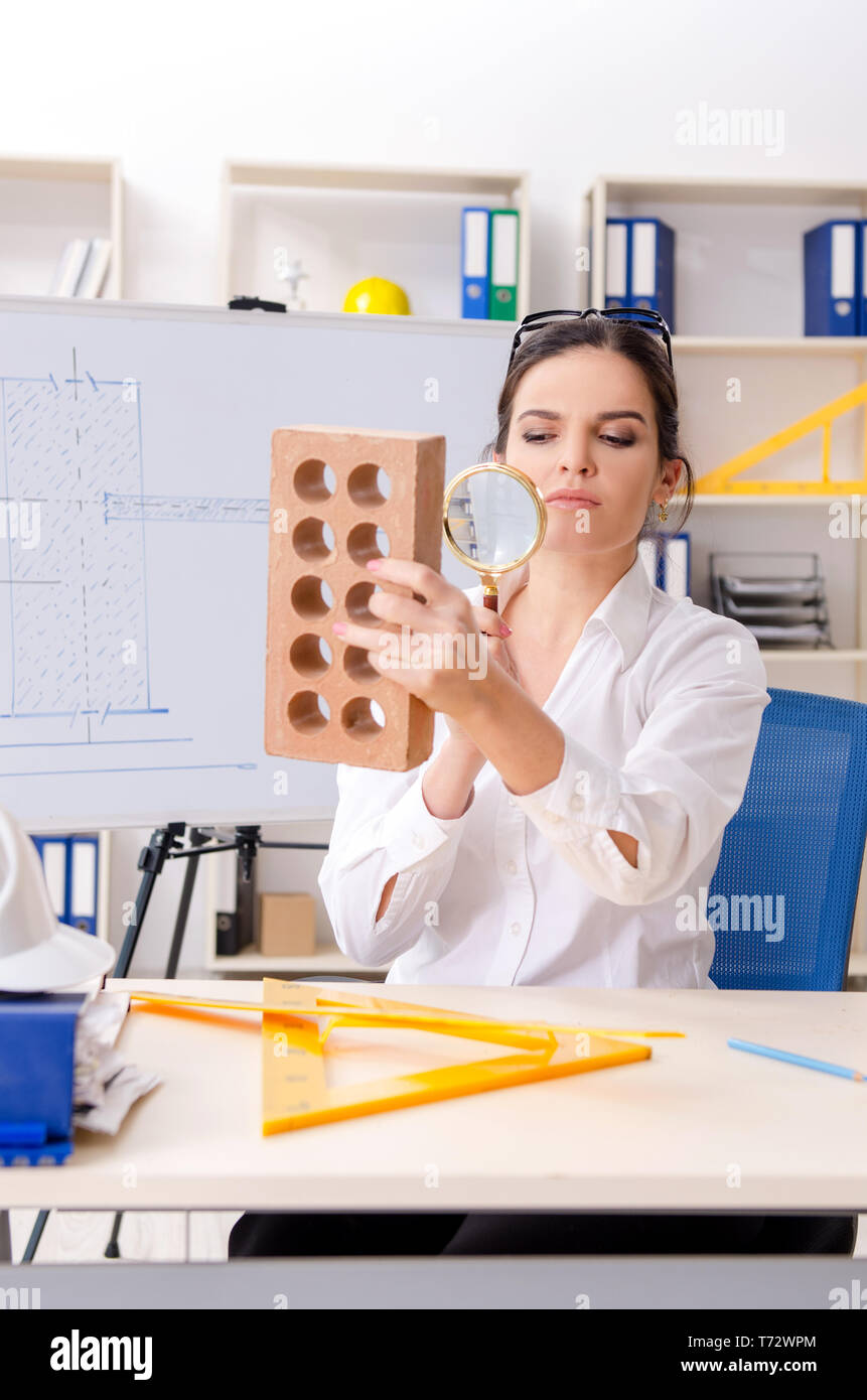 Female architect working in the office Stock Photo - Alamy