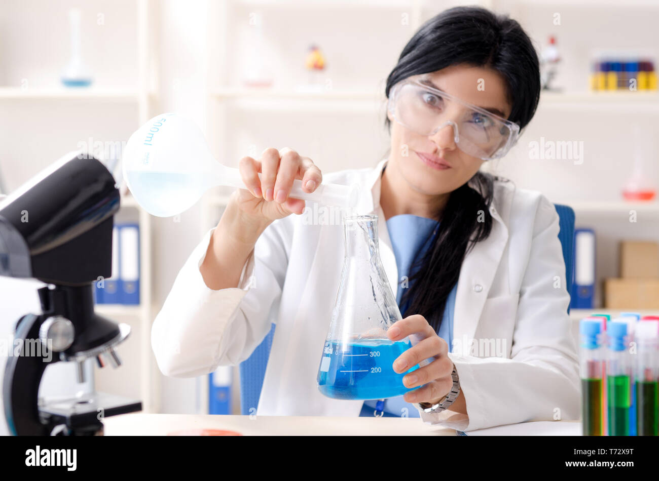 Female scientist mixing chemical solution hi-res stock photography and ...