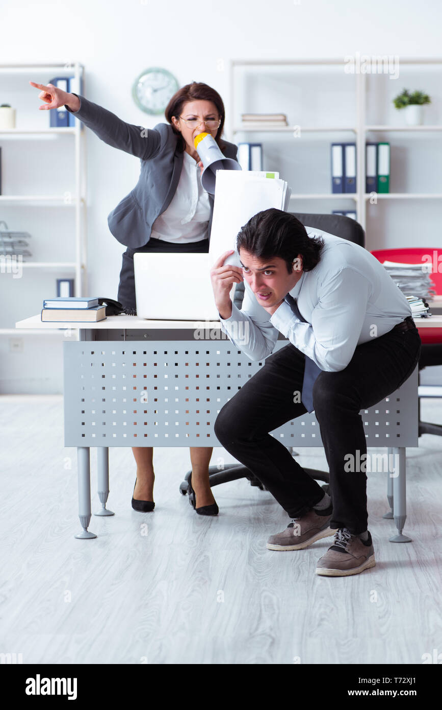 Old female boss and young male employee in the off hi-res stock ...
