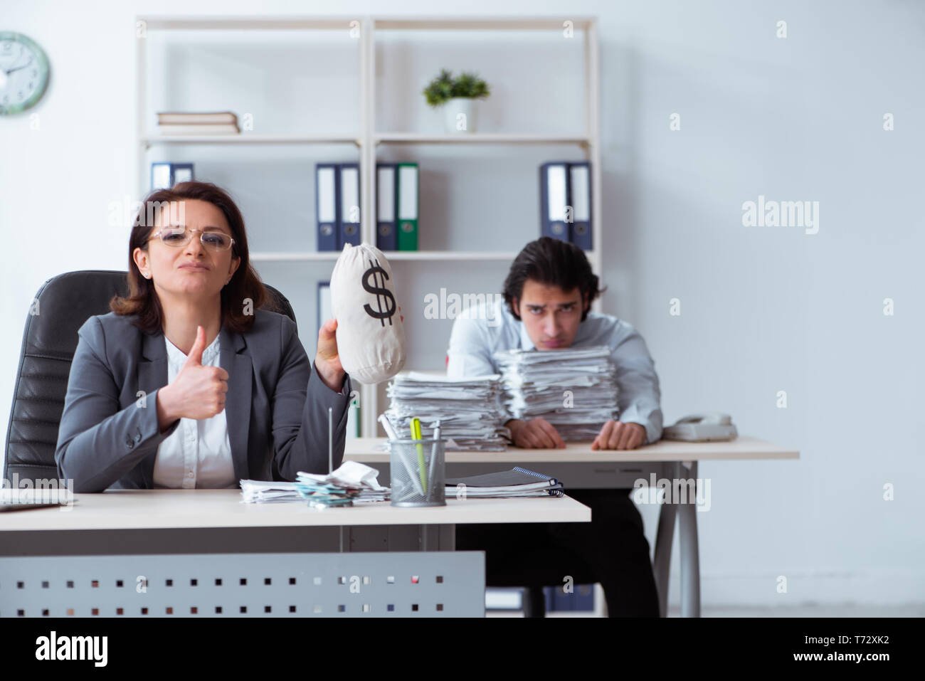 Old female boss and young male employee in the office Stock Photo - Alamy