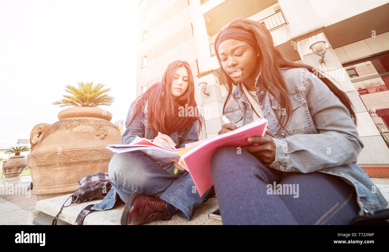 group of multi-ethnic students waiting and studying on the bench Stock ...