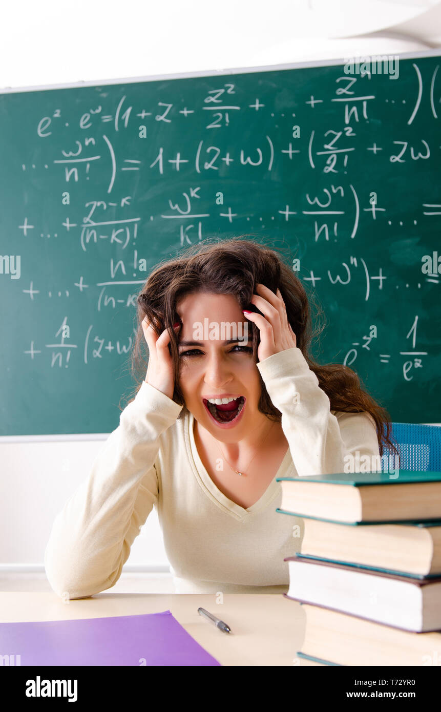 Young female math teacher in front of chalkboard Stock Photo - Alamy
