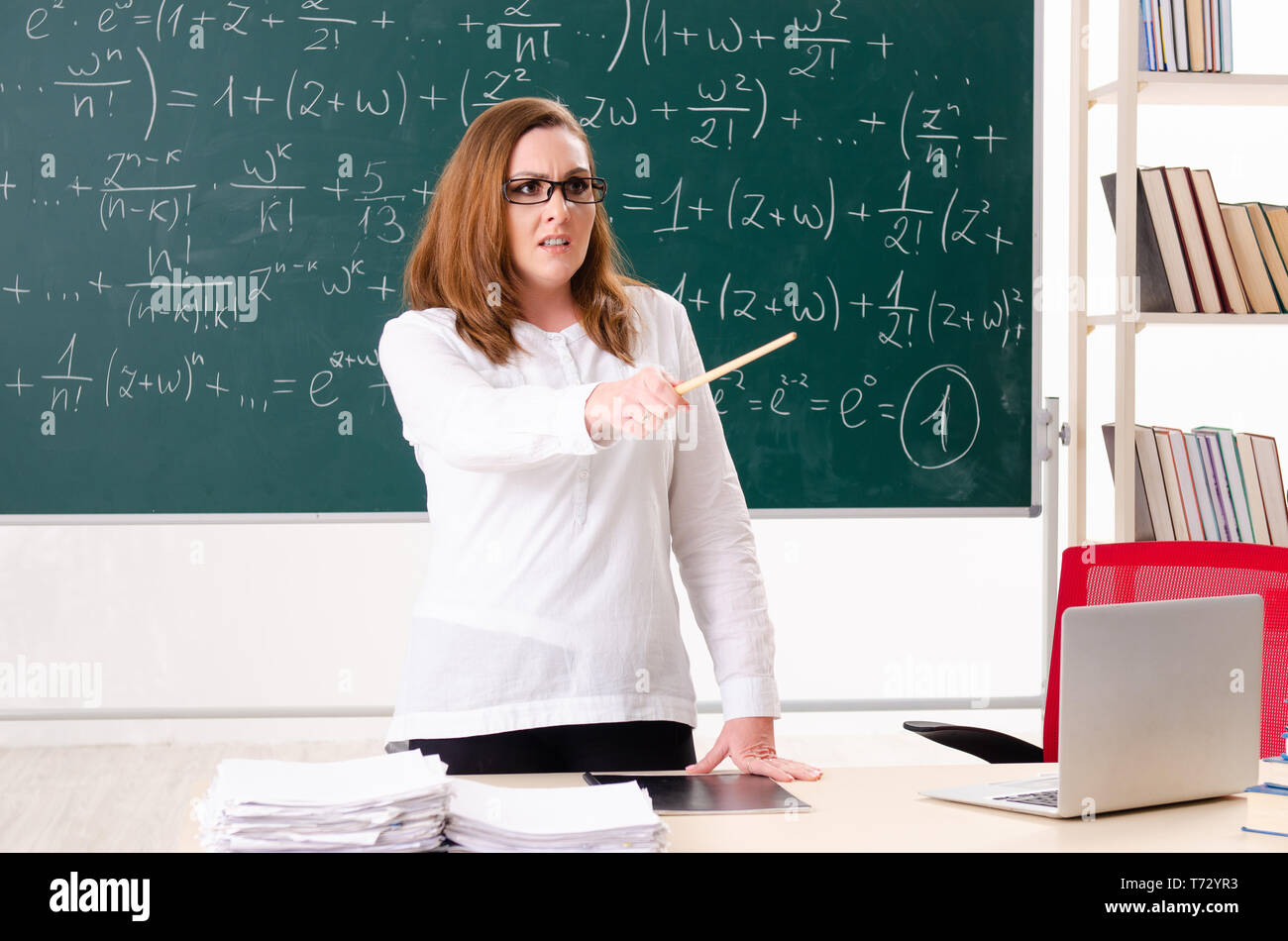 Female math teacher in the classroom Stock Photo - Alamy