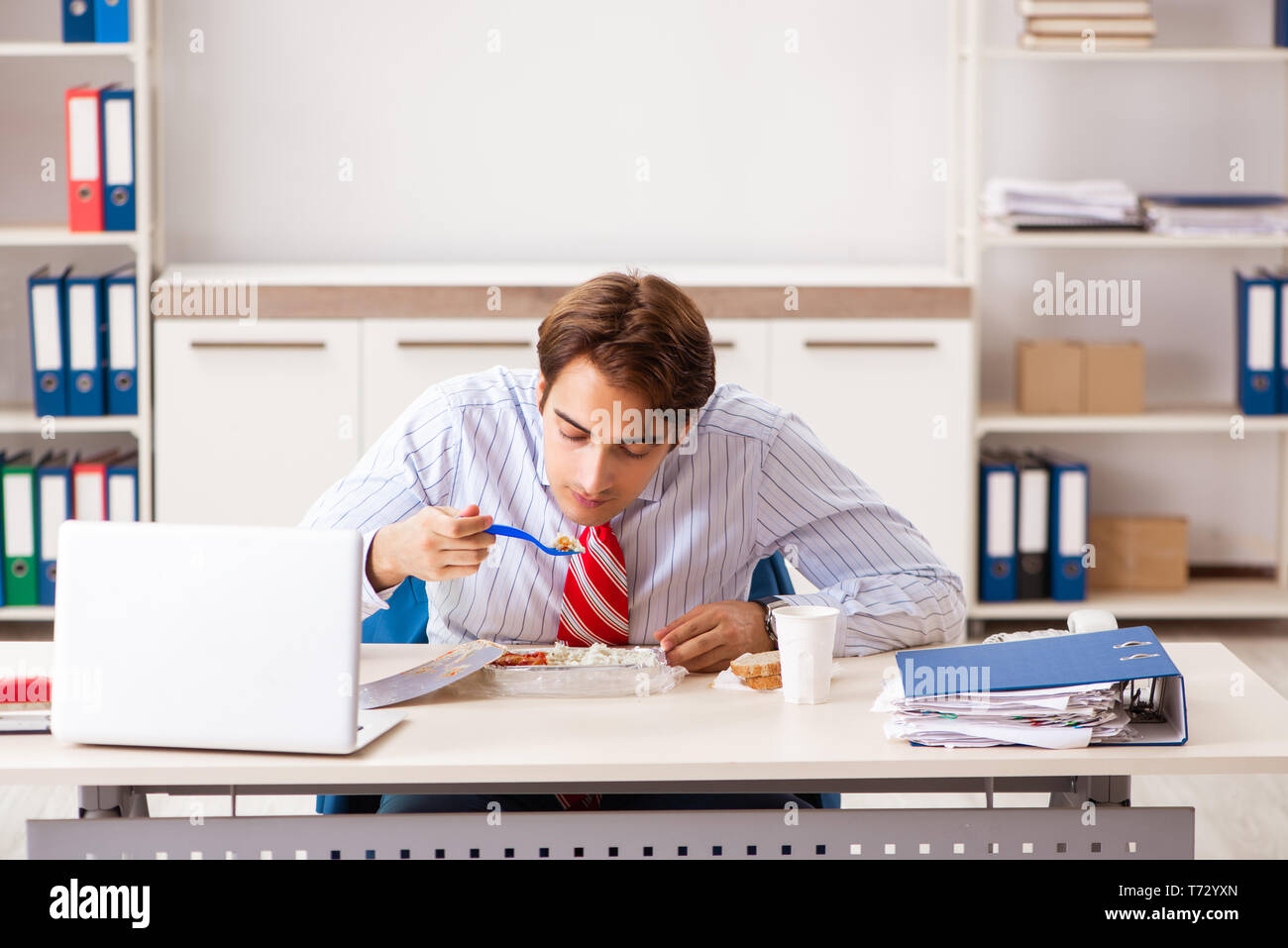 Man having meal at work during break Stock Photo - Alamy